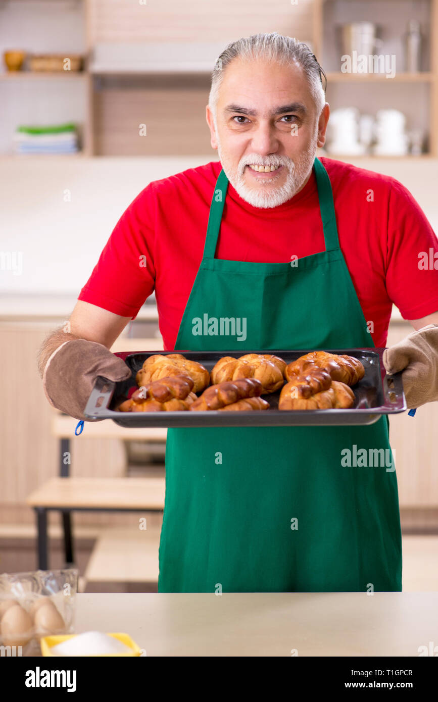 Happy baker presenting loaf bread hi-res stock photography and images ...