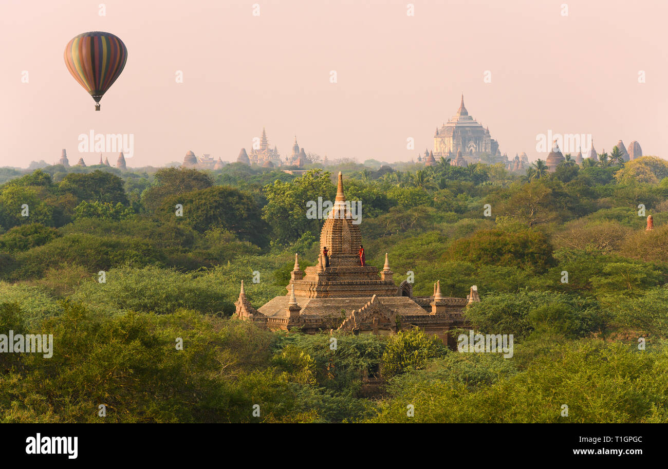 A unidentified Burmese couple, wearing a traditional Longyi, are taking ...