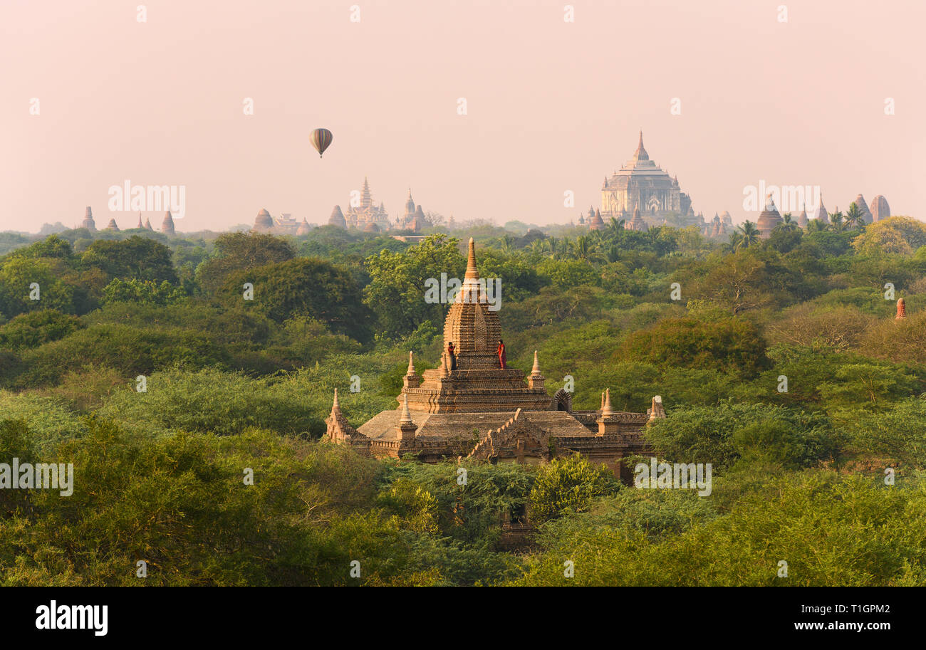 A unidentified Burmese couple, wearing a traditional Longyi, are taking ...