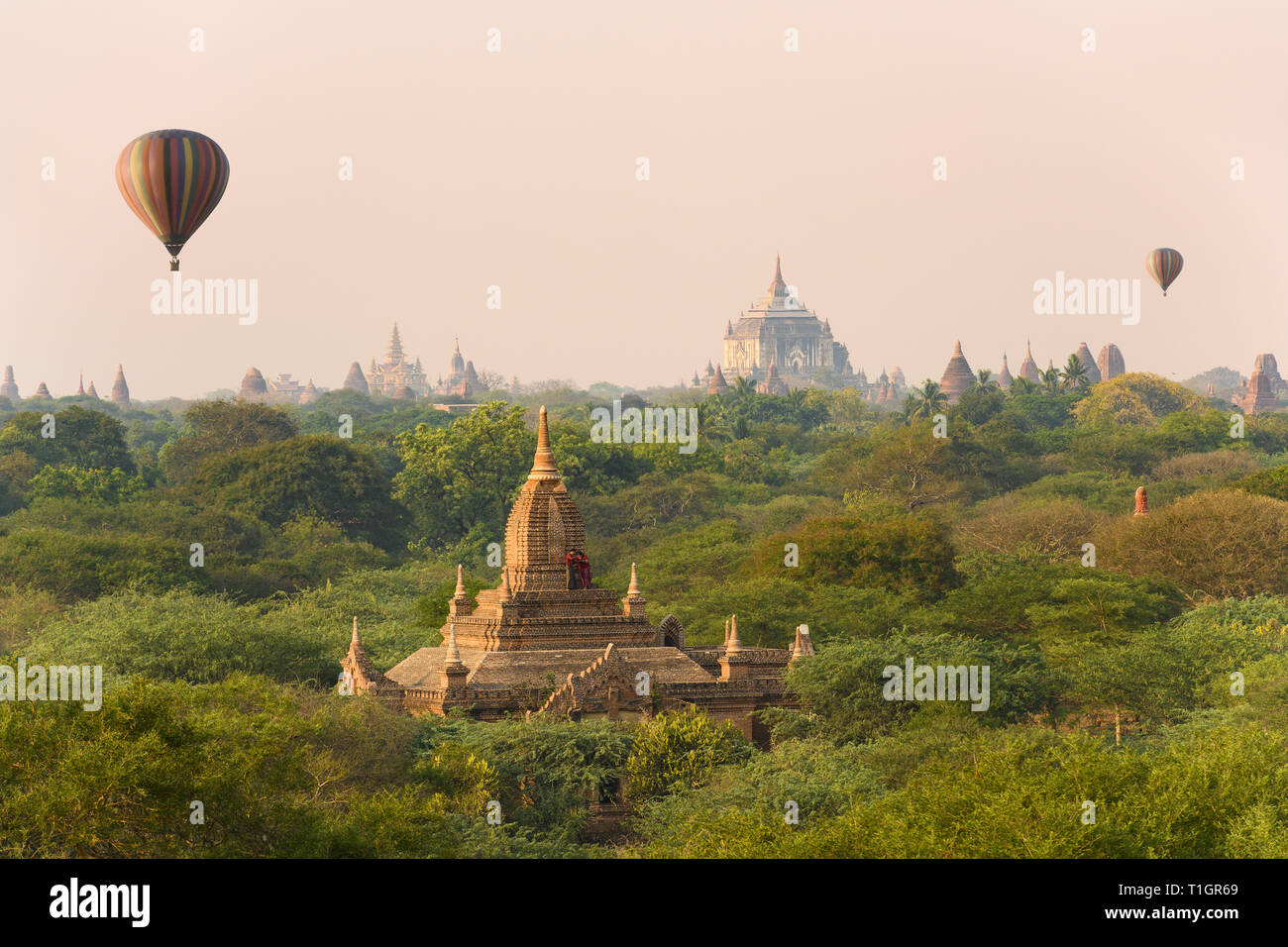 A unidentified Burmese couple, wearing a traditional Longyi, are taking ...