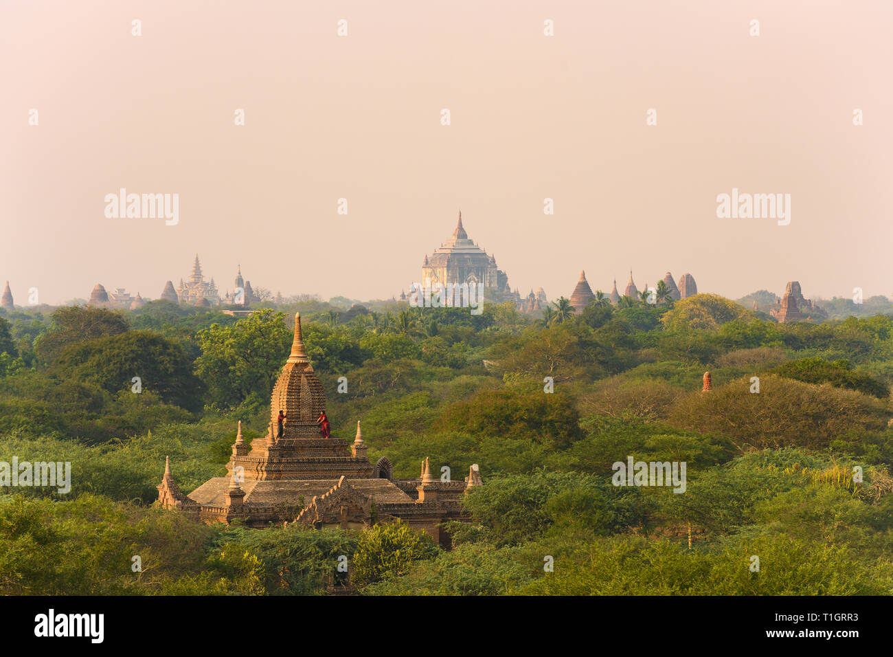 A unidentified Burmese couple, wearing a traditional Longyi, are taking ...