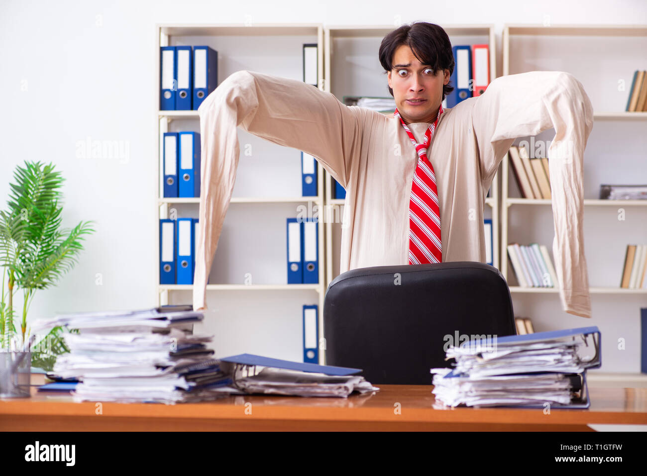 Crazy young man in straitjacket at the office Stock Photo - Alamy