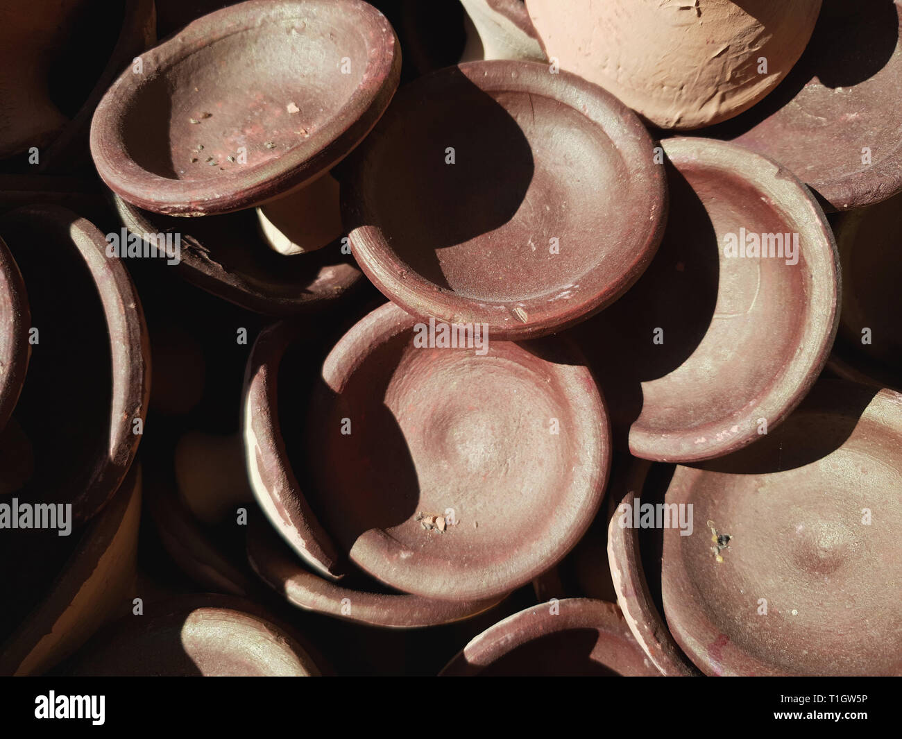 Brown clay round plates in a heap Stock Photo - Alamy