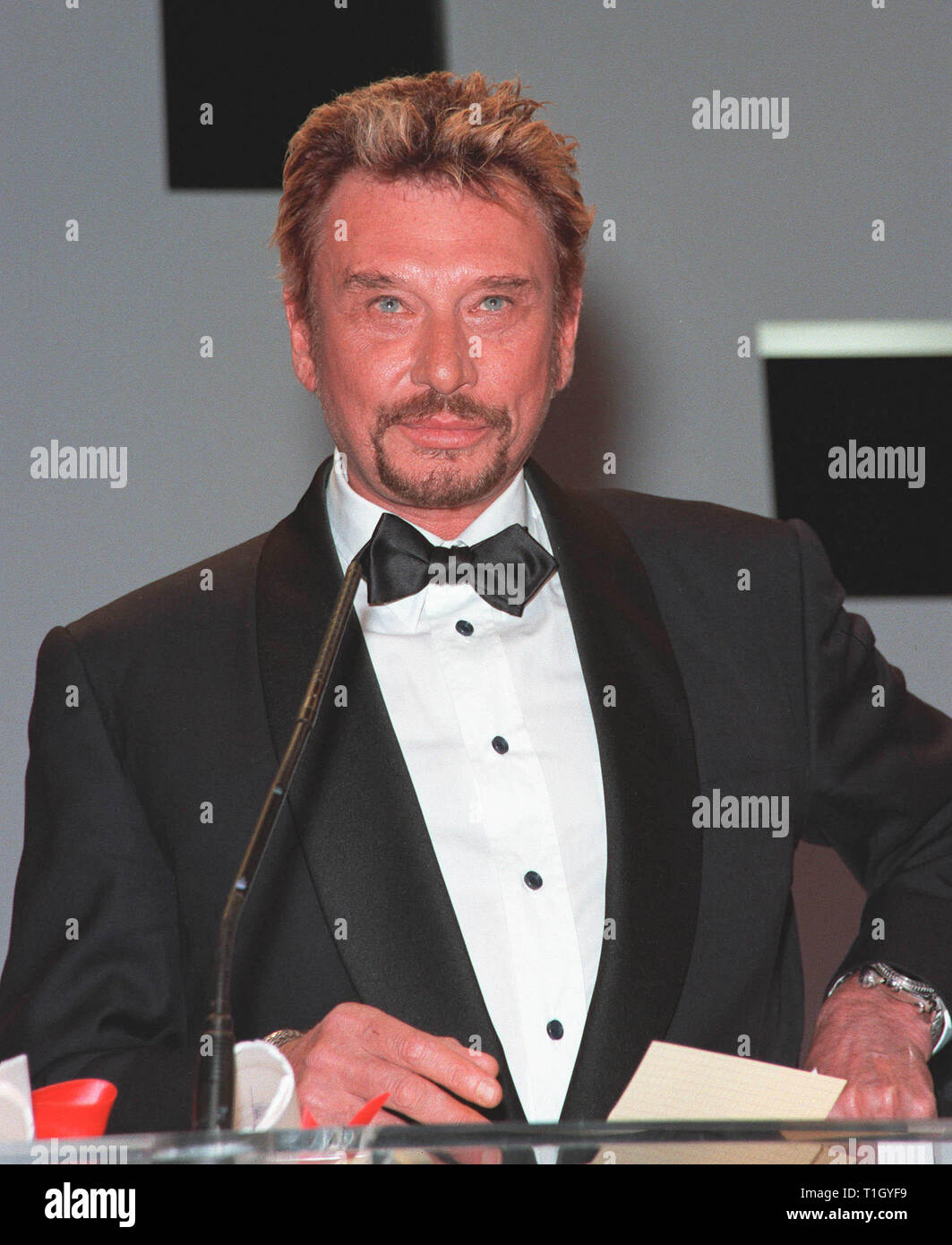 CANNES, FRANCE: 23 MAY 1999: French actor JOHNNY HALLYDAY at the 52nd ...