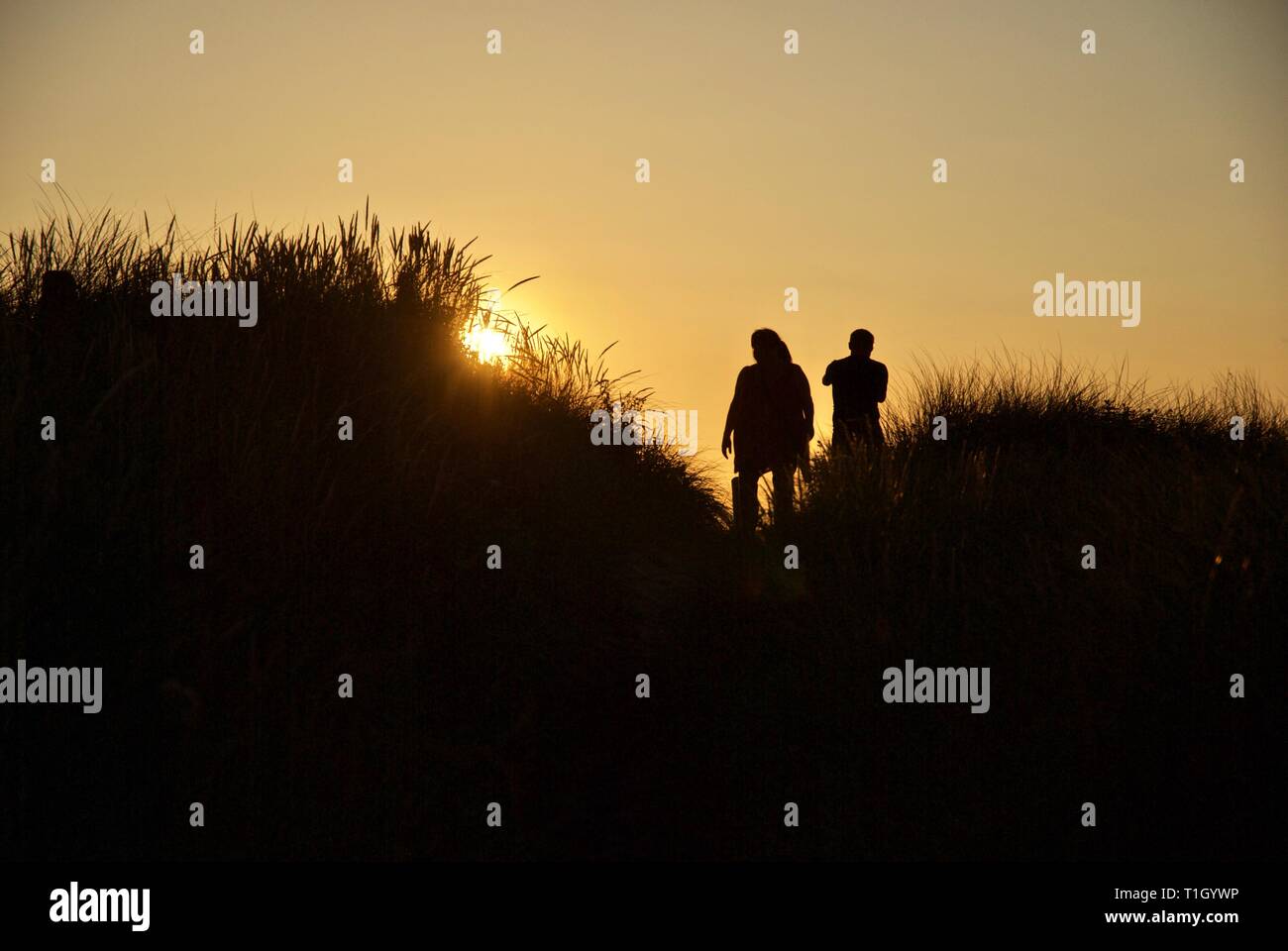 Distant figures on the beach, Rhosneigr, Anglesey, North Wales, UK ...