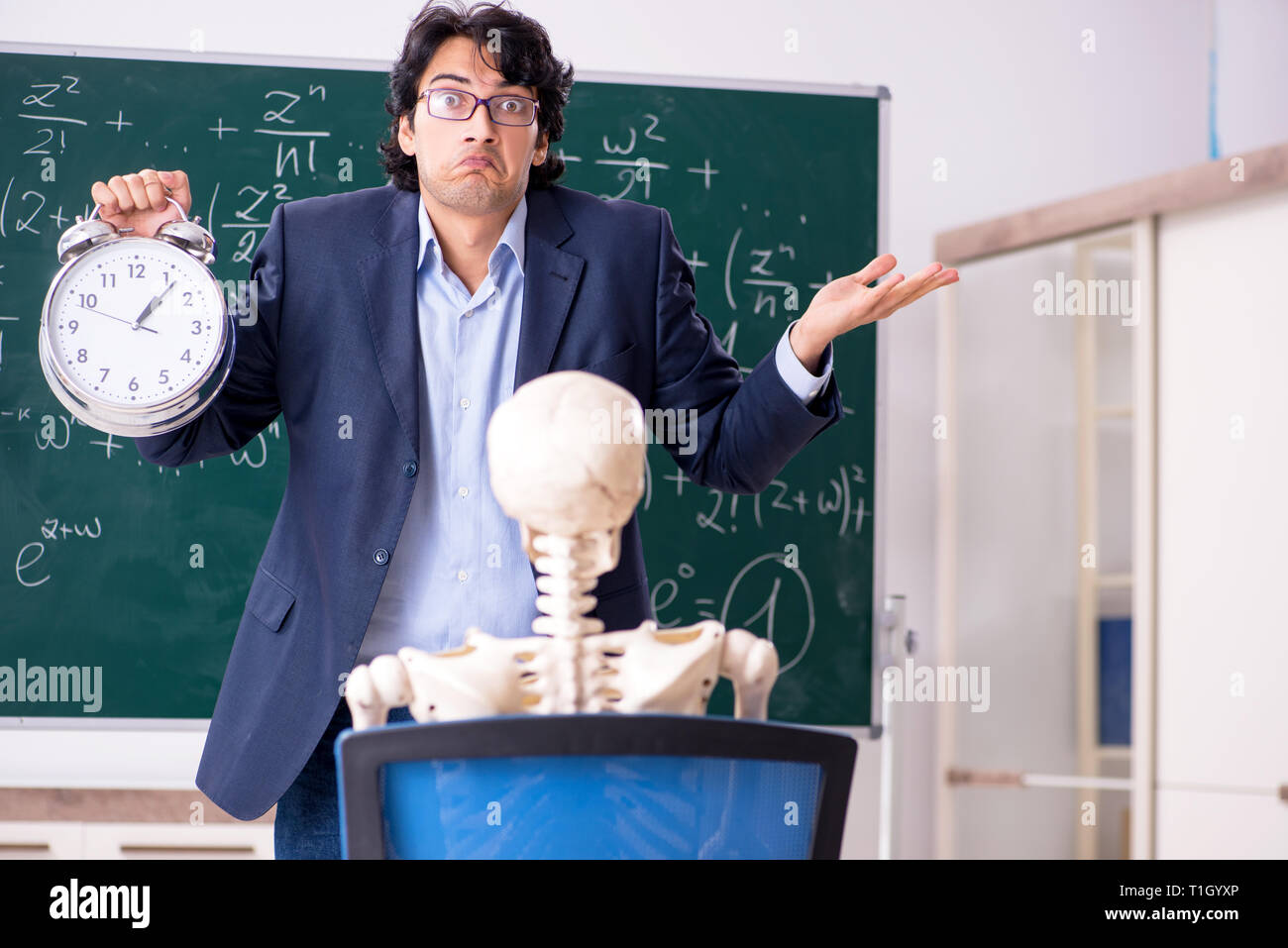 Young male math teacher and student skeleton Stock Photo - Alamy
