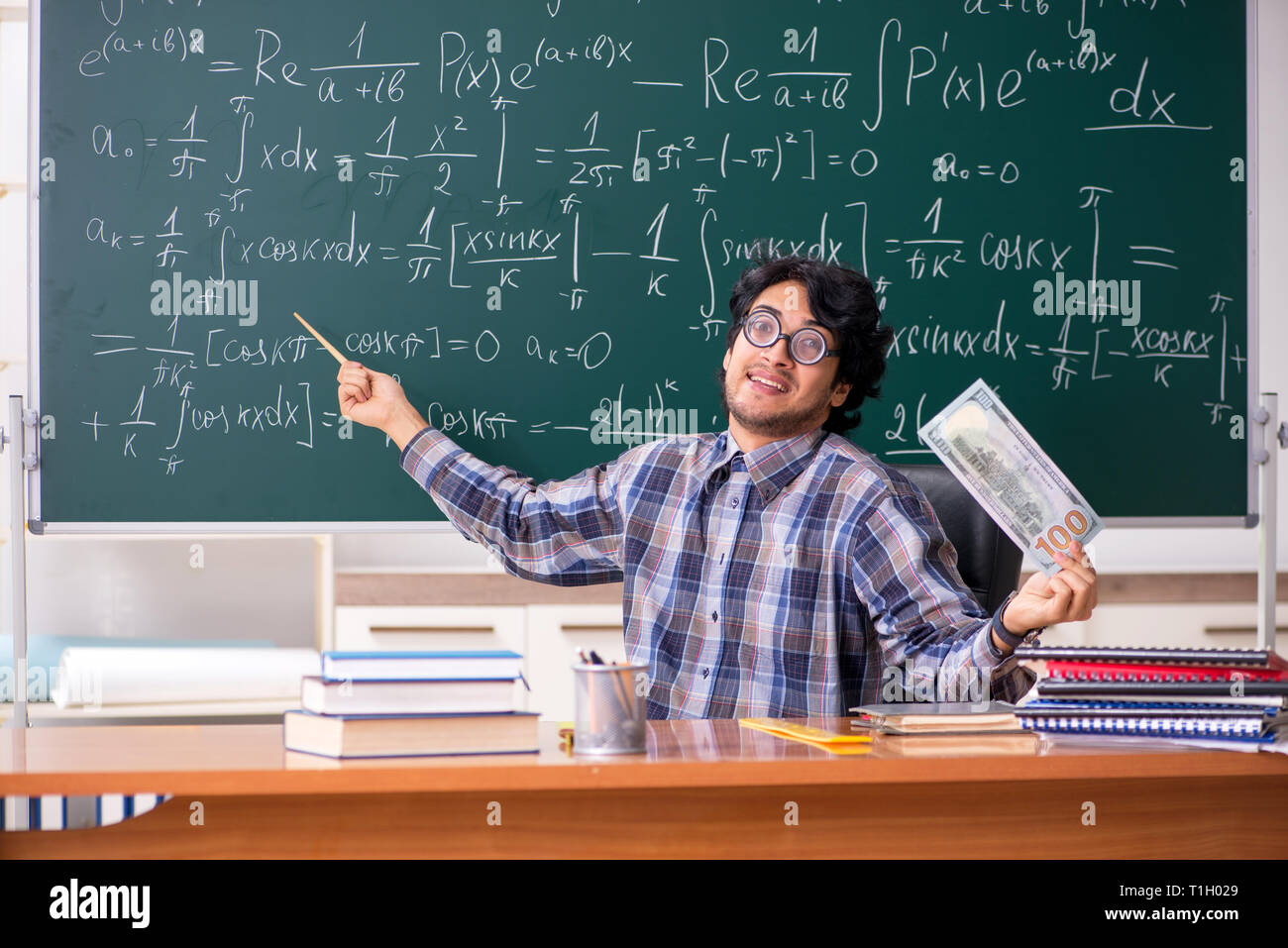 Funny male math teacher in the classroom Stock Photo - Alamy