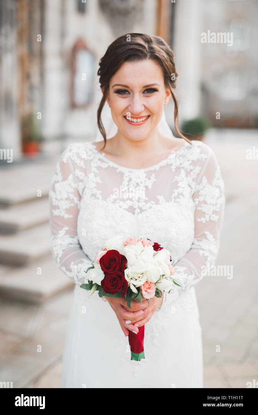 Portrait of stunning bride with long hair posing with great bouquet ...