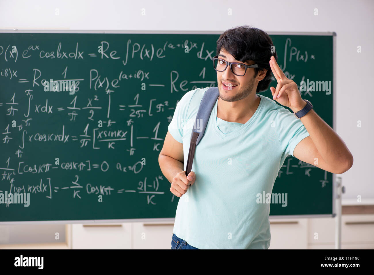 Young male student mathematician in front of chalkboard Stock Photo - Alamy