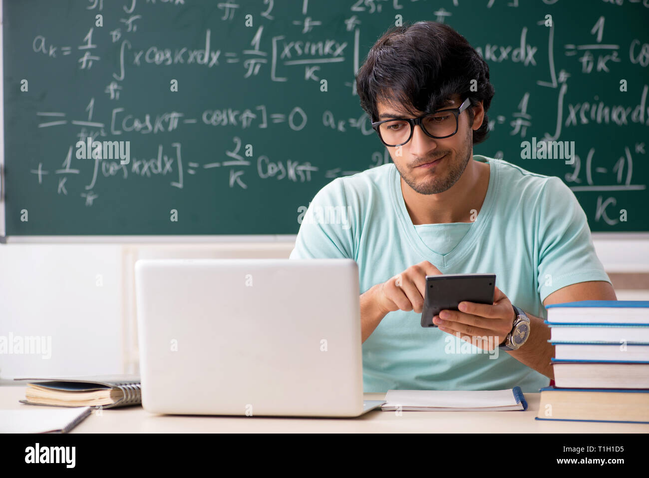 Young male student mathematician in front of chalkboard Stock Photo - Alamy