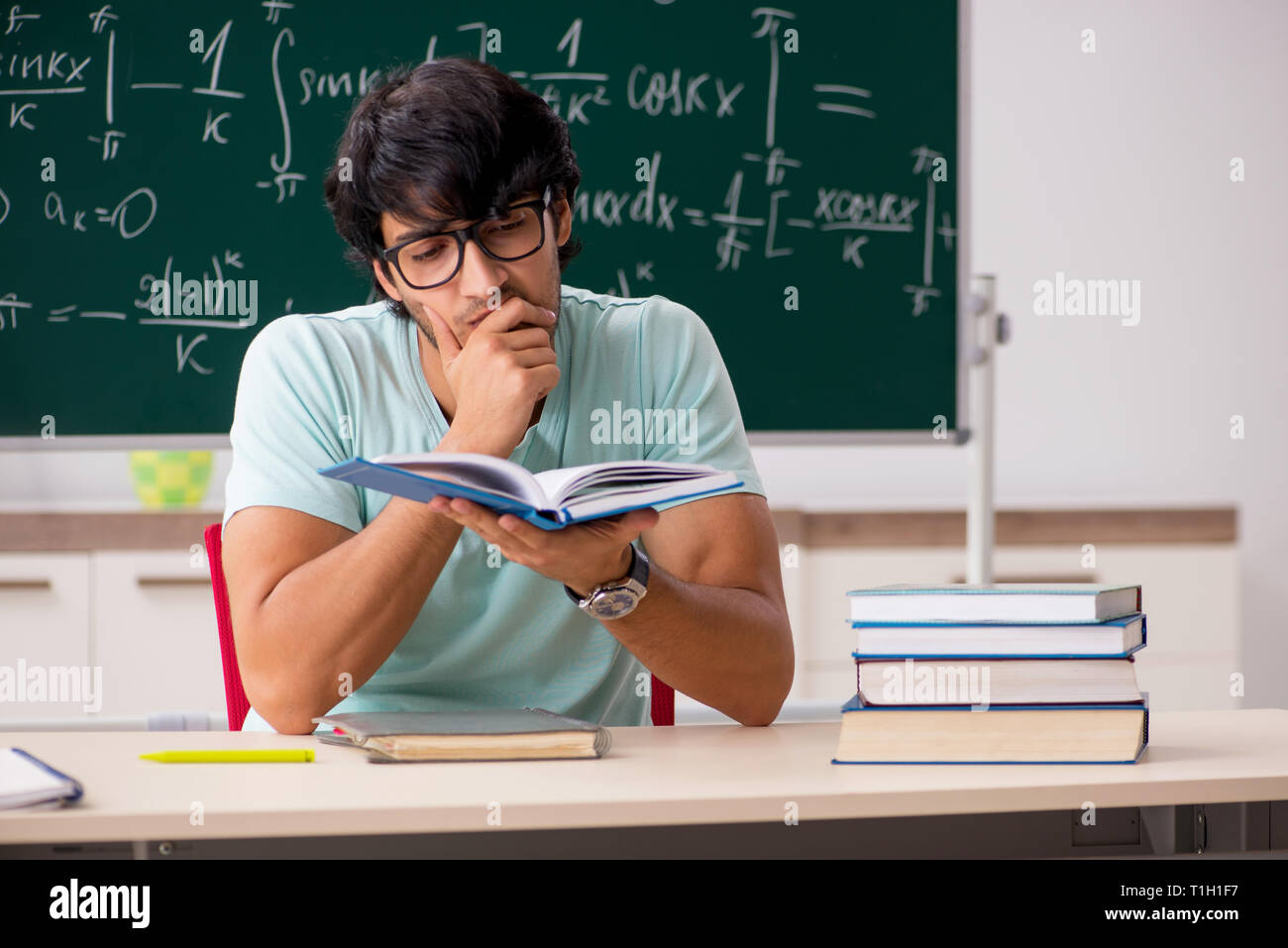 Young male student mathematician in front of chalkboard Stock Photo - Alamy