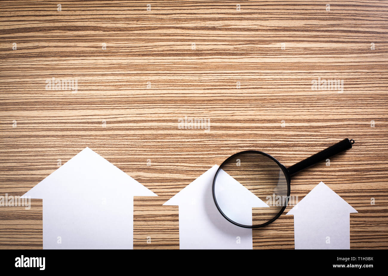 paper house with Magnifying Glass Stock Photo - Alamy