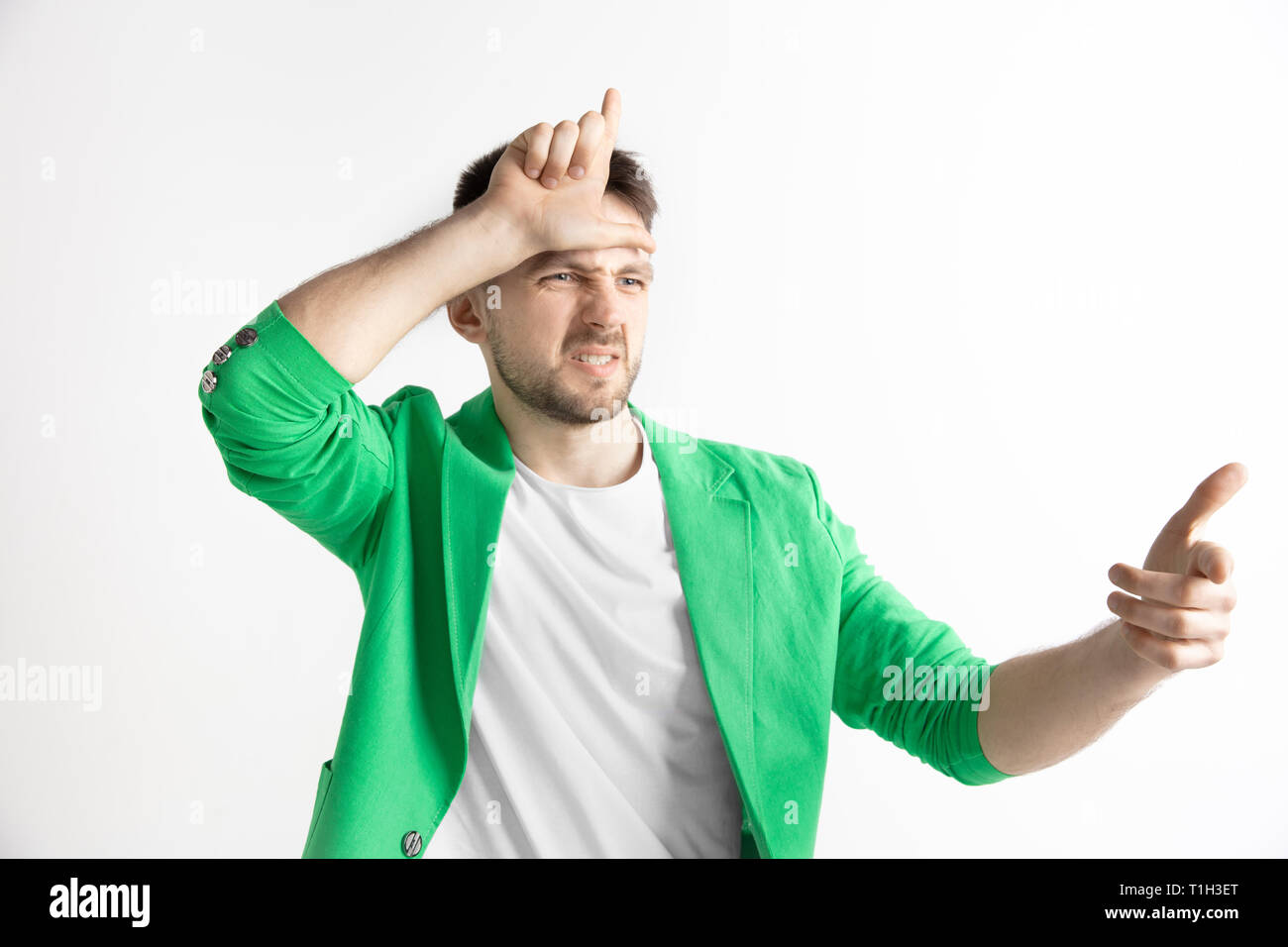 Losers go home. Portrait of angry guy showing loser sign over forehead ...