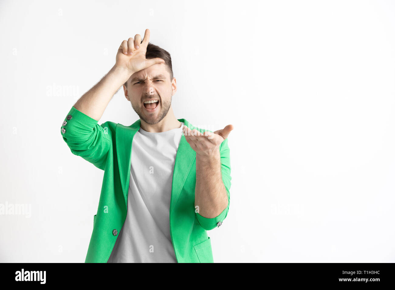 Losers go home. Portrait of angry guy showing loser sign over forehead ...