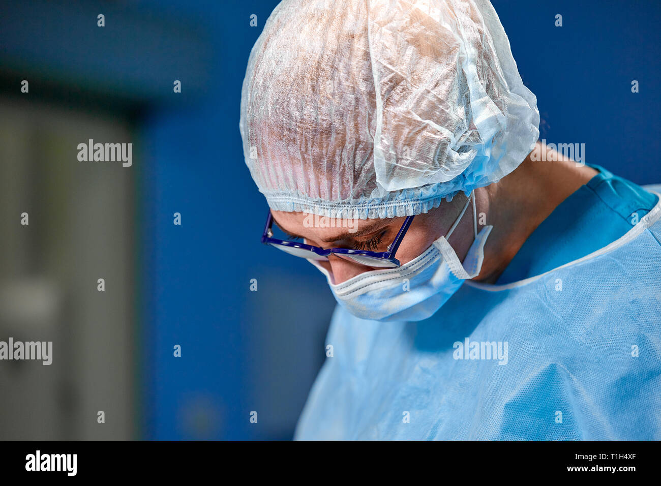 Close up portrait of female surgeon doctor wearing protective mask and ...
