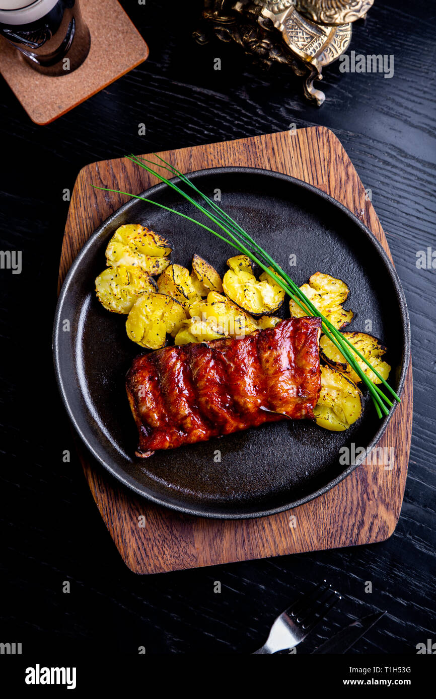 Close up Gourmet Main Dish with Grilled Pork Rib and Fried Potatoes on ...