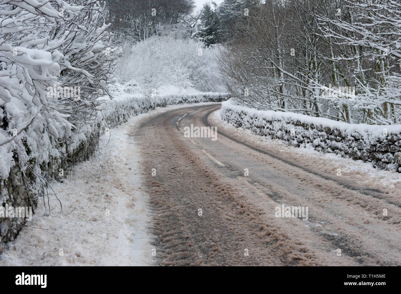 Slush and snow covered empty road in rural location Stock Photo - Alamy