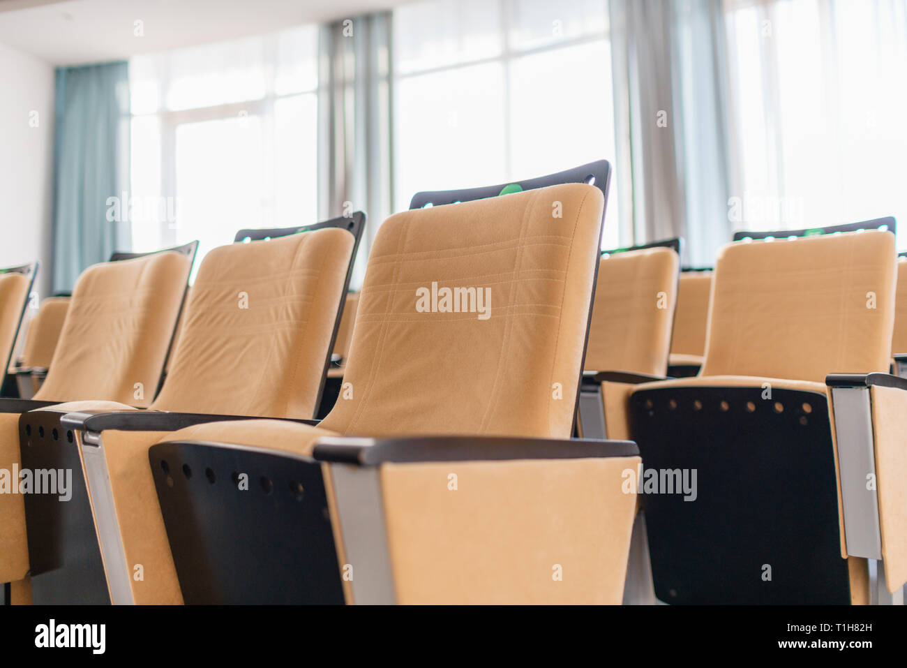 Folding chairs close-up. Big empty modern conference hall in luxury ...