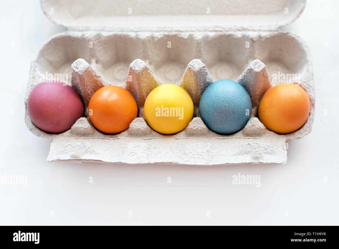 Easter vibes. Top view of colored Ester eggs in paper container ...
