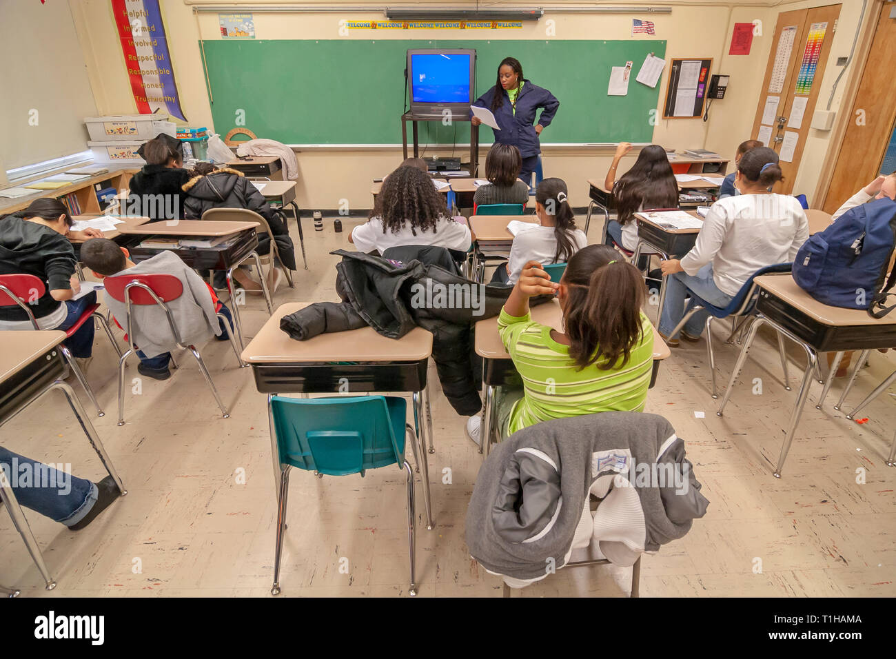 Female Teacher Teaching Her Students In A Classroom High Resolution ...