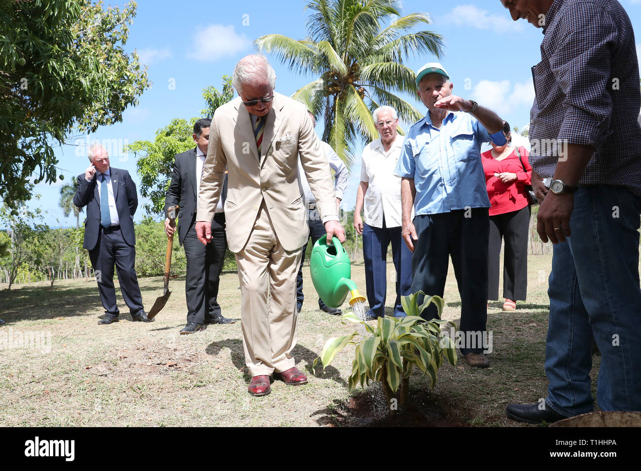 The Prince of Wales waters a plant during a visit to the Finca Marta ...