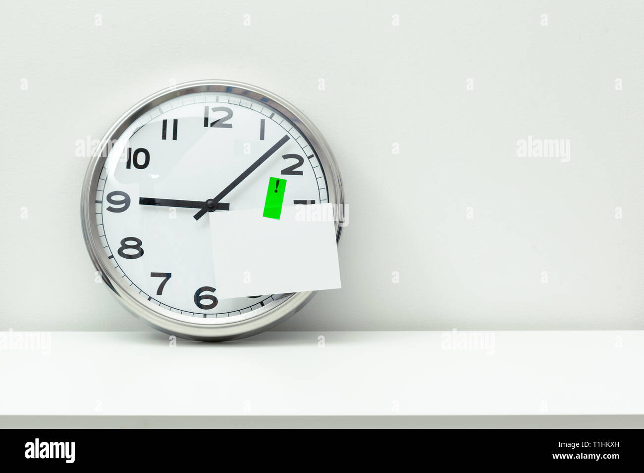 Clock at an office table Stock Photo - Alamy