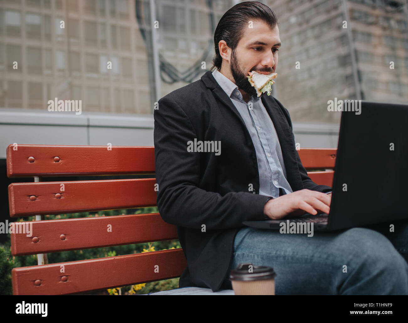 Business man eating snack walking hi-res stock photography and images ...