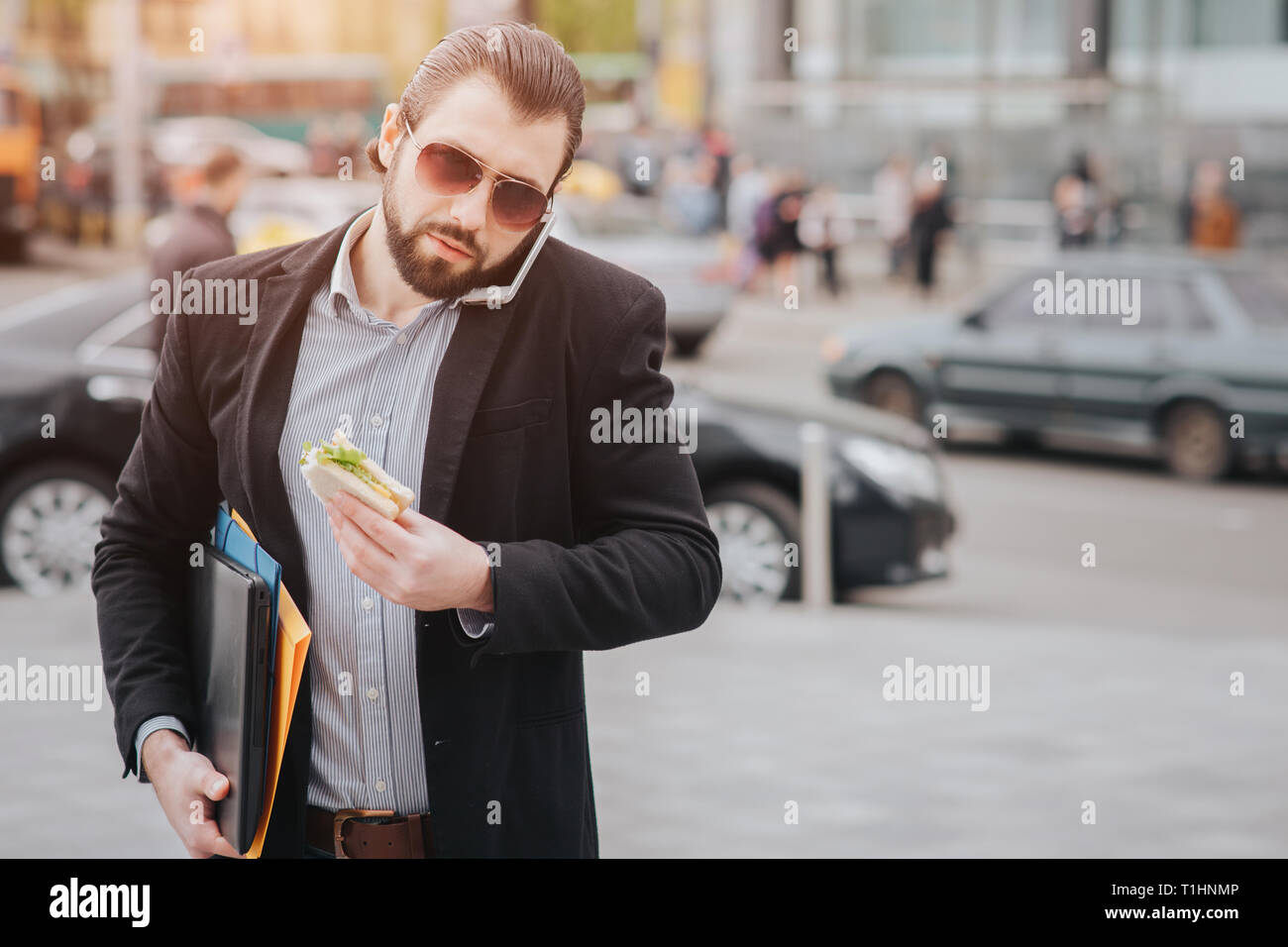 Busy man is in a hurry, he does not have time, he is going to eat snack ...