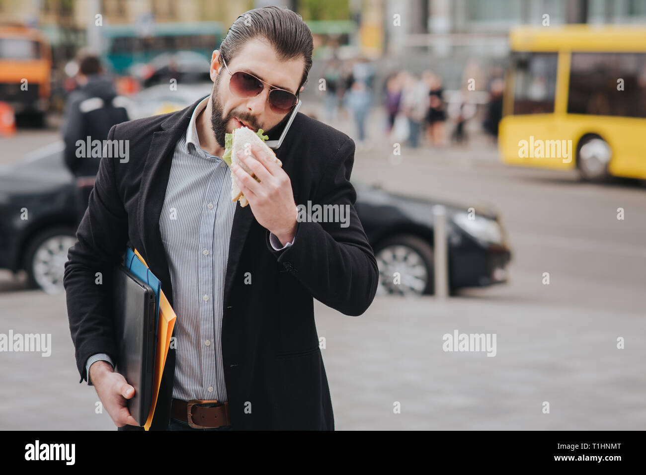 Business man eating snack walking hi-res stock photography and images ...