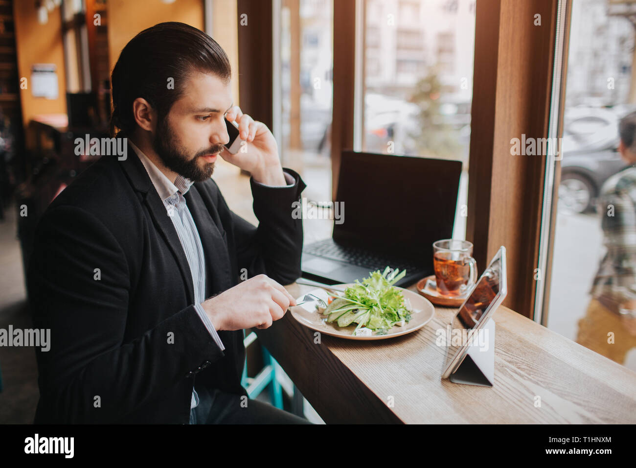 Busy man is in a hurry, he does not have time, he is going to eating ...