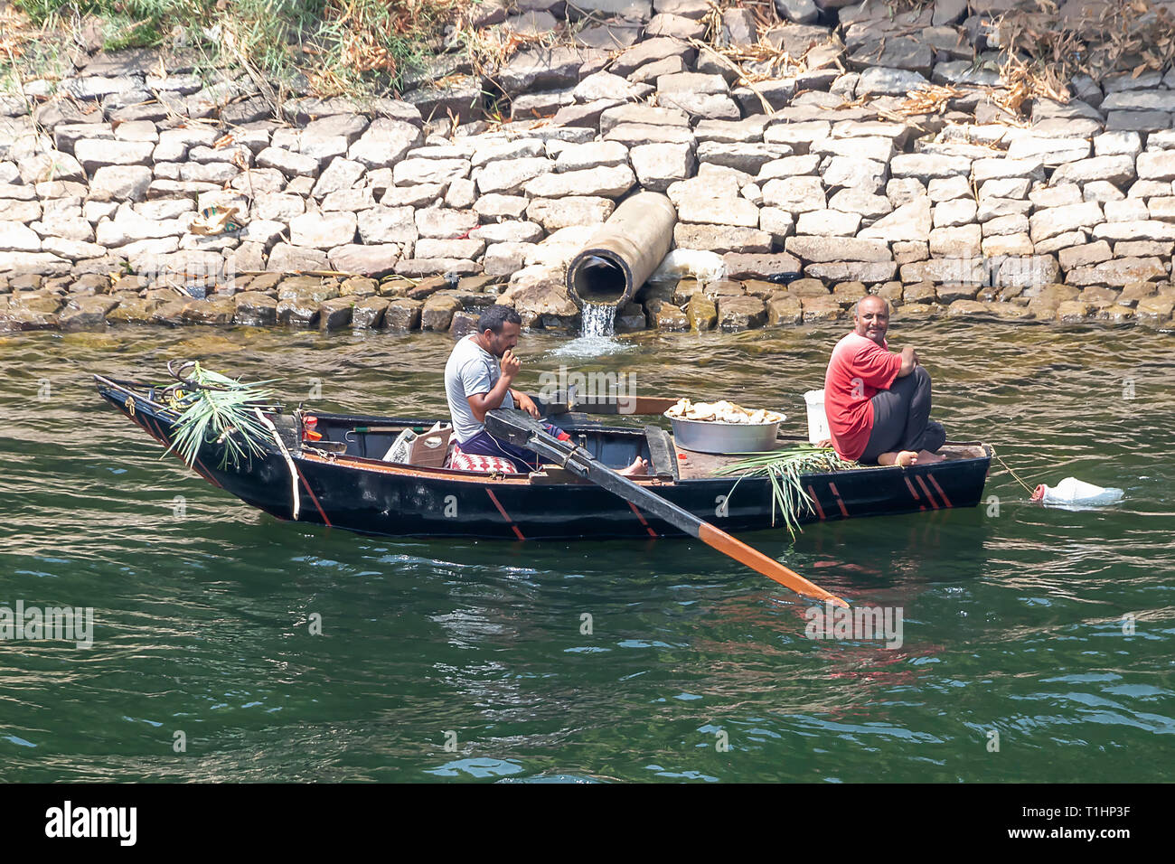 Aswan, Egypt - September 13, 2018: Fishers in small row boat fishing in ...
