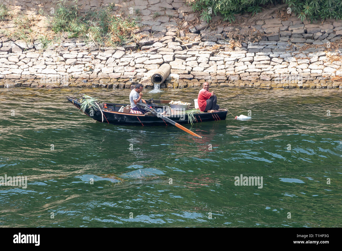 Aswan, Egypt - September 13, 2018: Fishers in small row boat fishing in ...