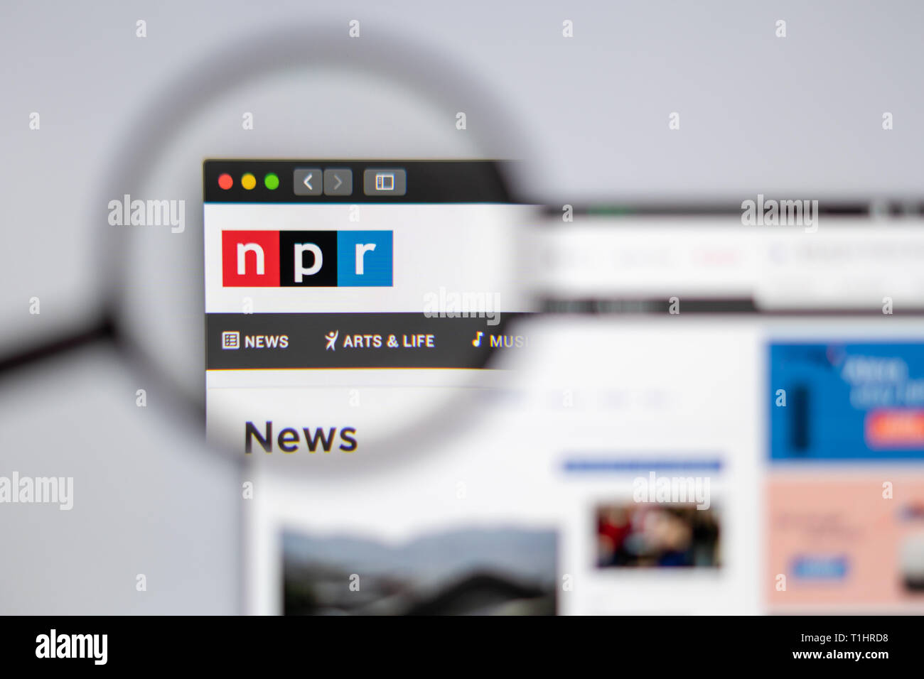 News media NPR website homepage. NPR logo visible through a magnifying ...