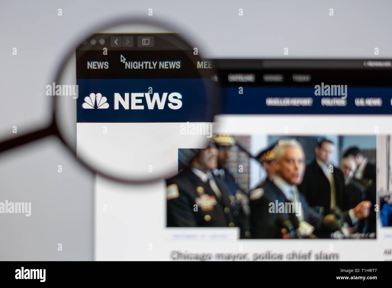News media NBC website homepage. NBC logo visible through a magnifying ...