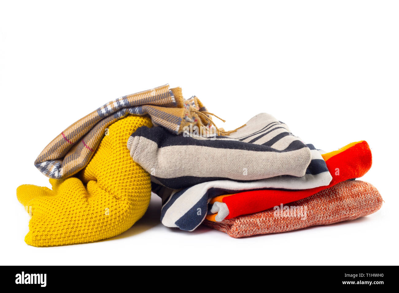 Stack of various sweaters isolated on white background Stock Photo - Alamy