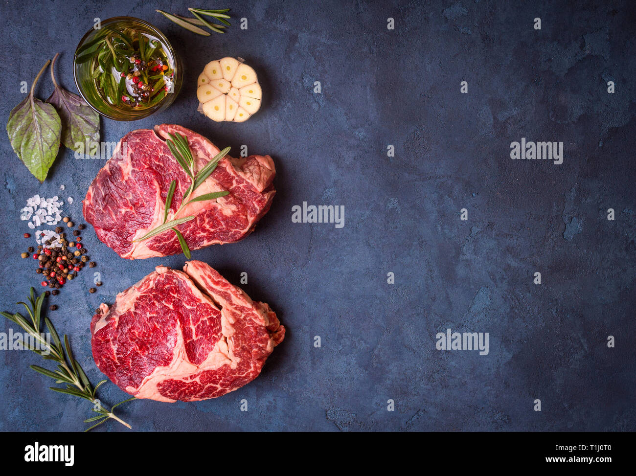 Raw meat steak on rustic concrete background ready to roasting Stock ...