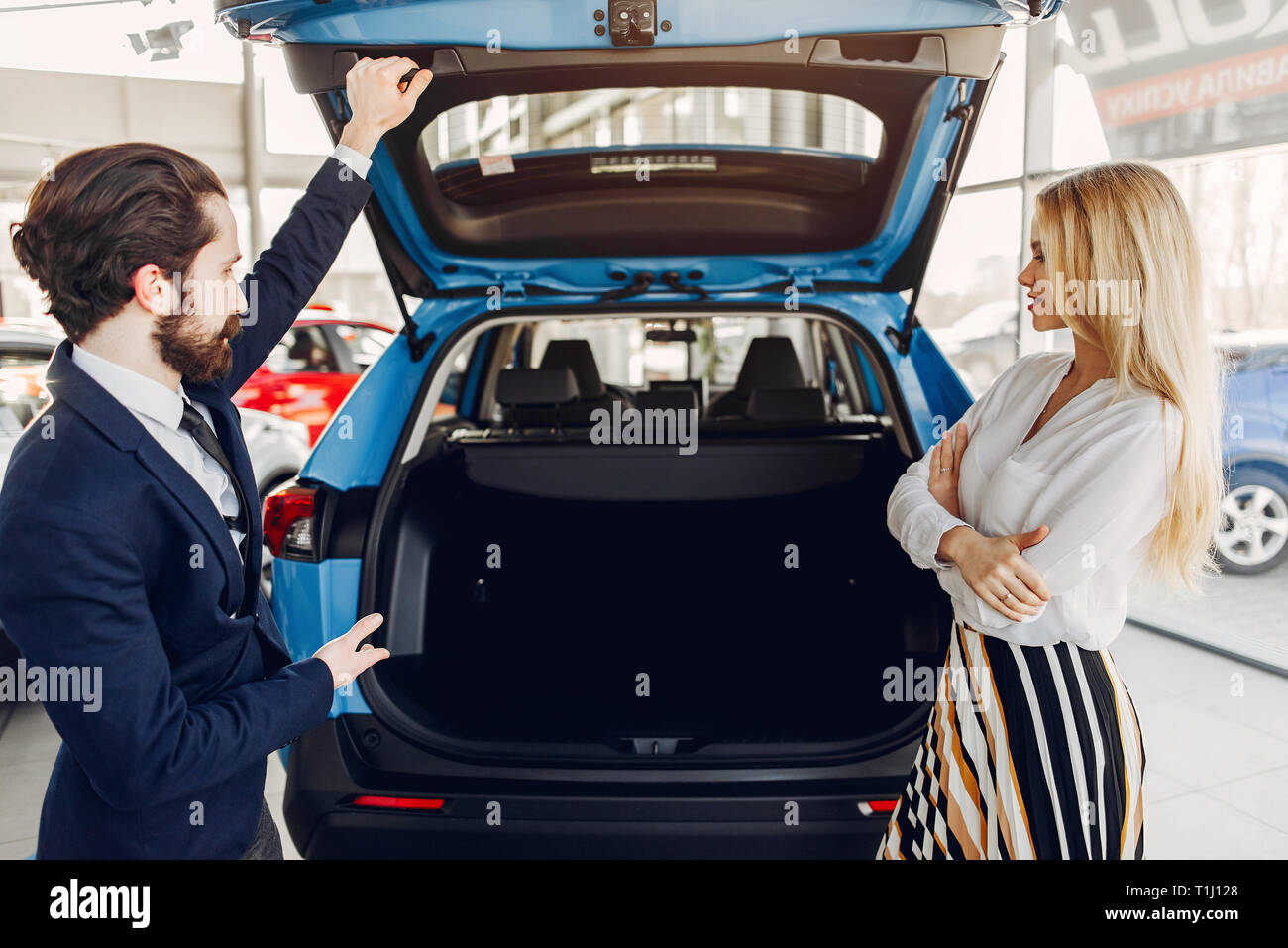 Stylish and elegant woman in a car salon Stock Photo - Alamy