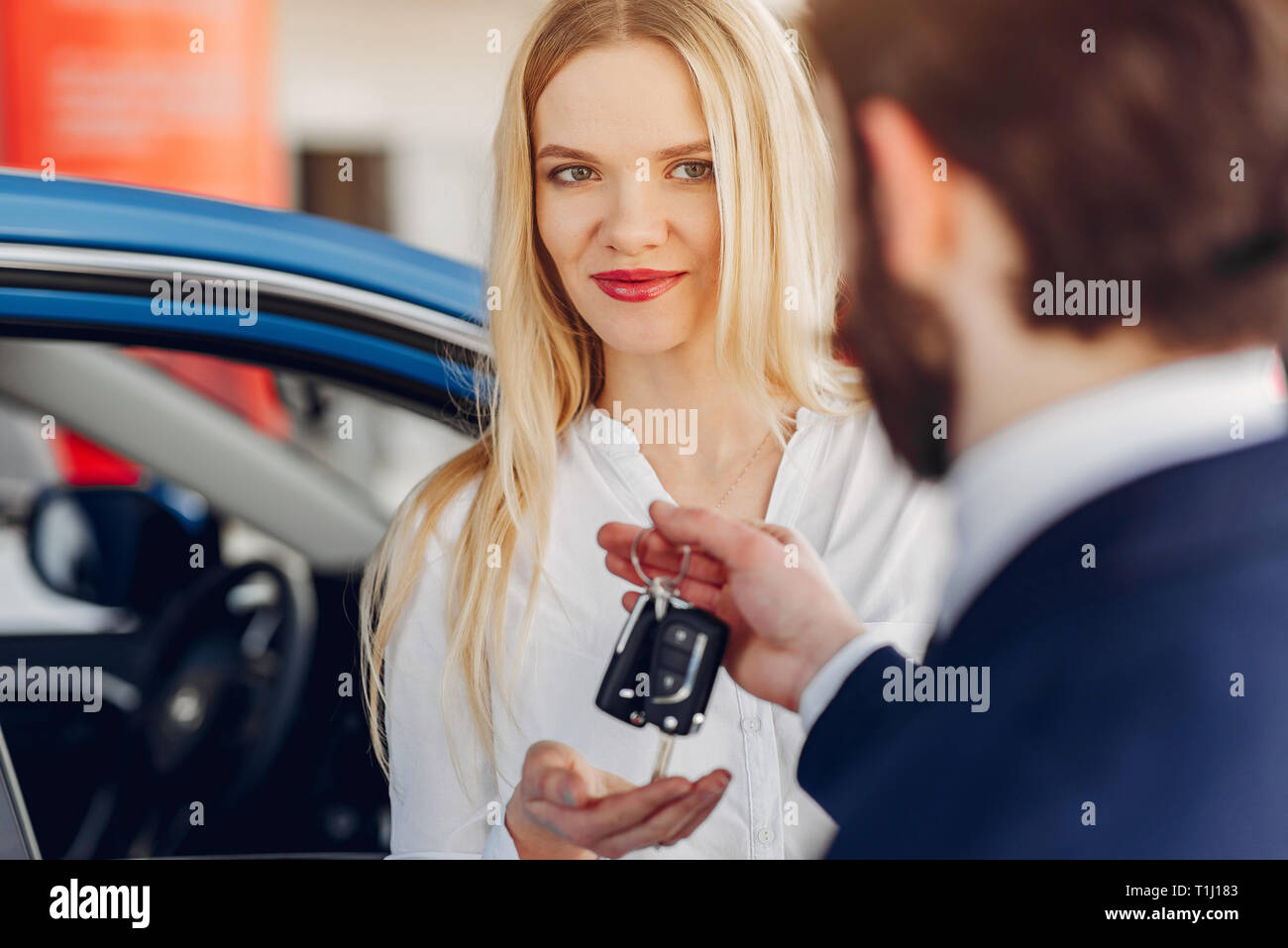 Stylish and elegant woman in a car salon Stock Photo - Alamy
