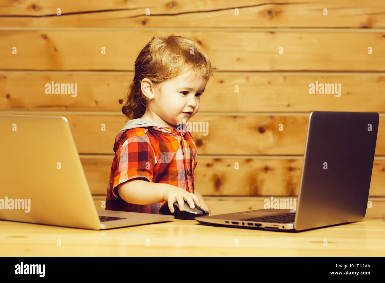 Cute boy plays on computers Stock Photo - Alamy