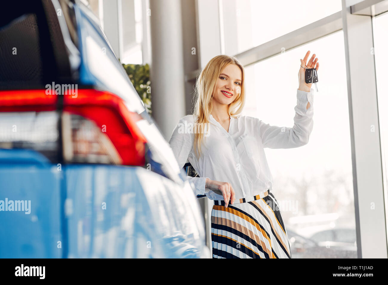 Stylish and elegant woman in a car salon Stock Photo - Alamy