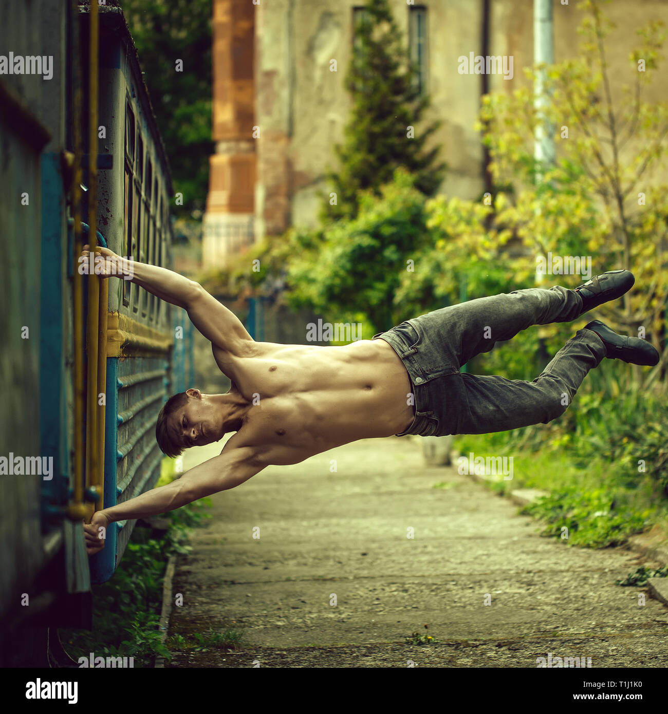Muscular guys near railway train Stock Photo - Alamy