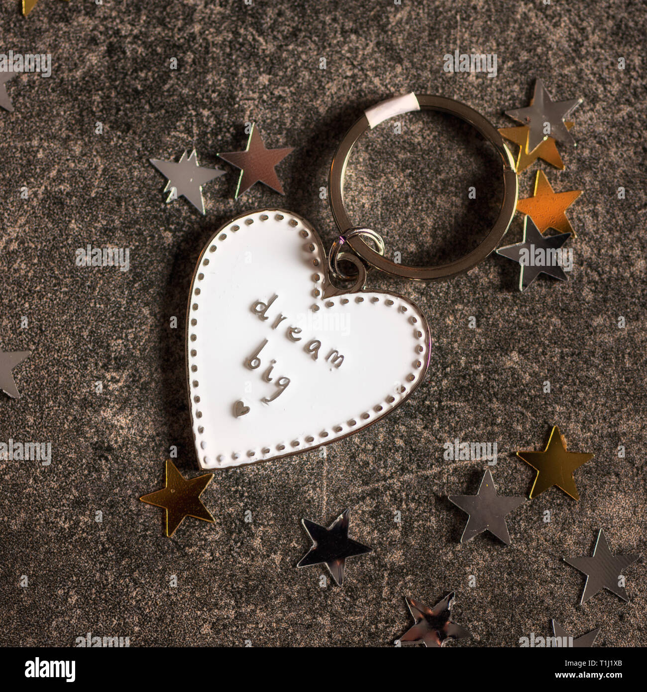 Keyring in the shape of heart and slogan DREAM BIG. Minimalist Concept ...