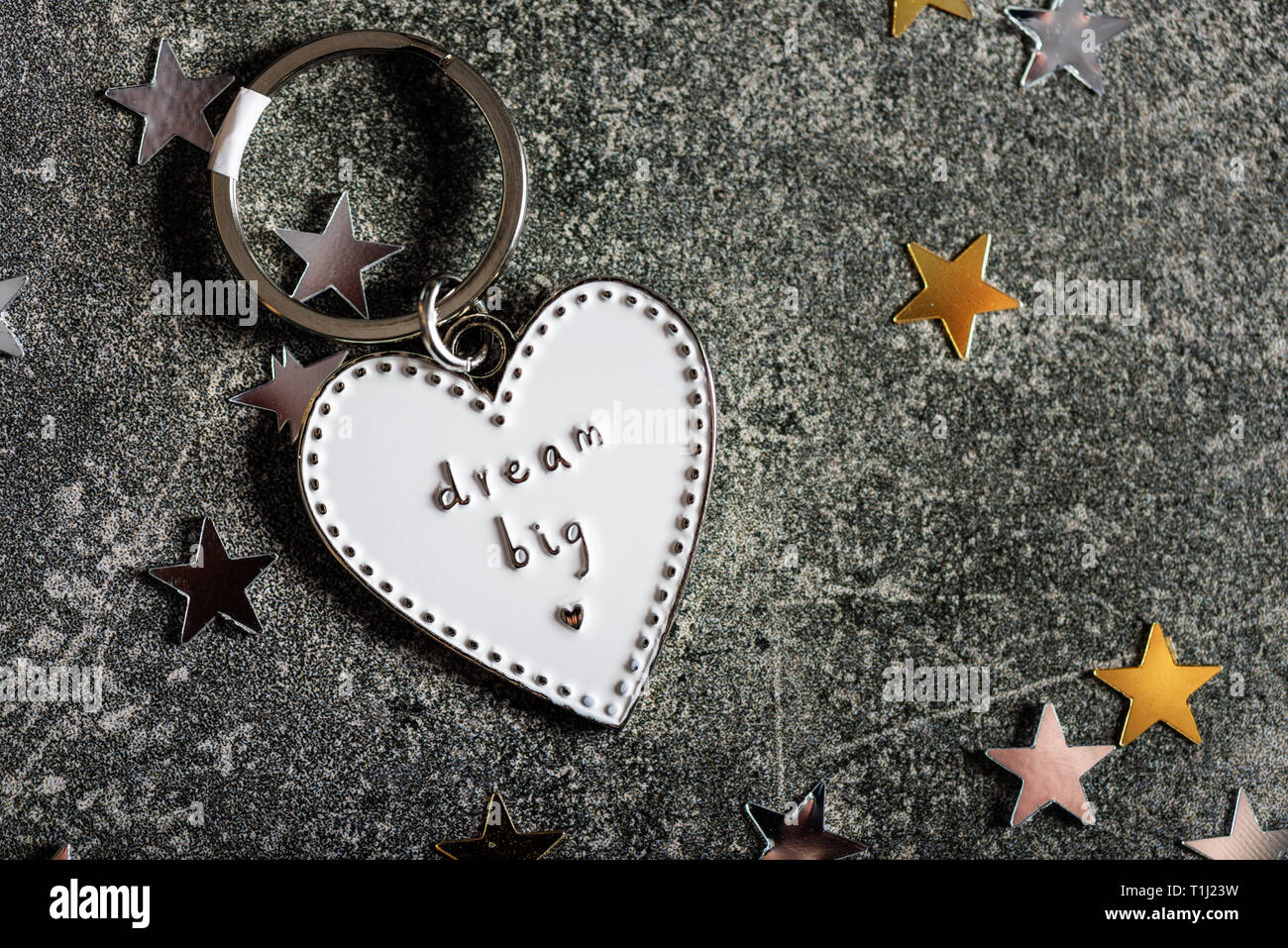Keyring in the shape of heart and slogan DREAM BIG. Minimalist Concept ...