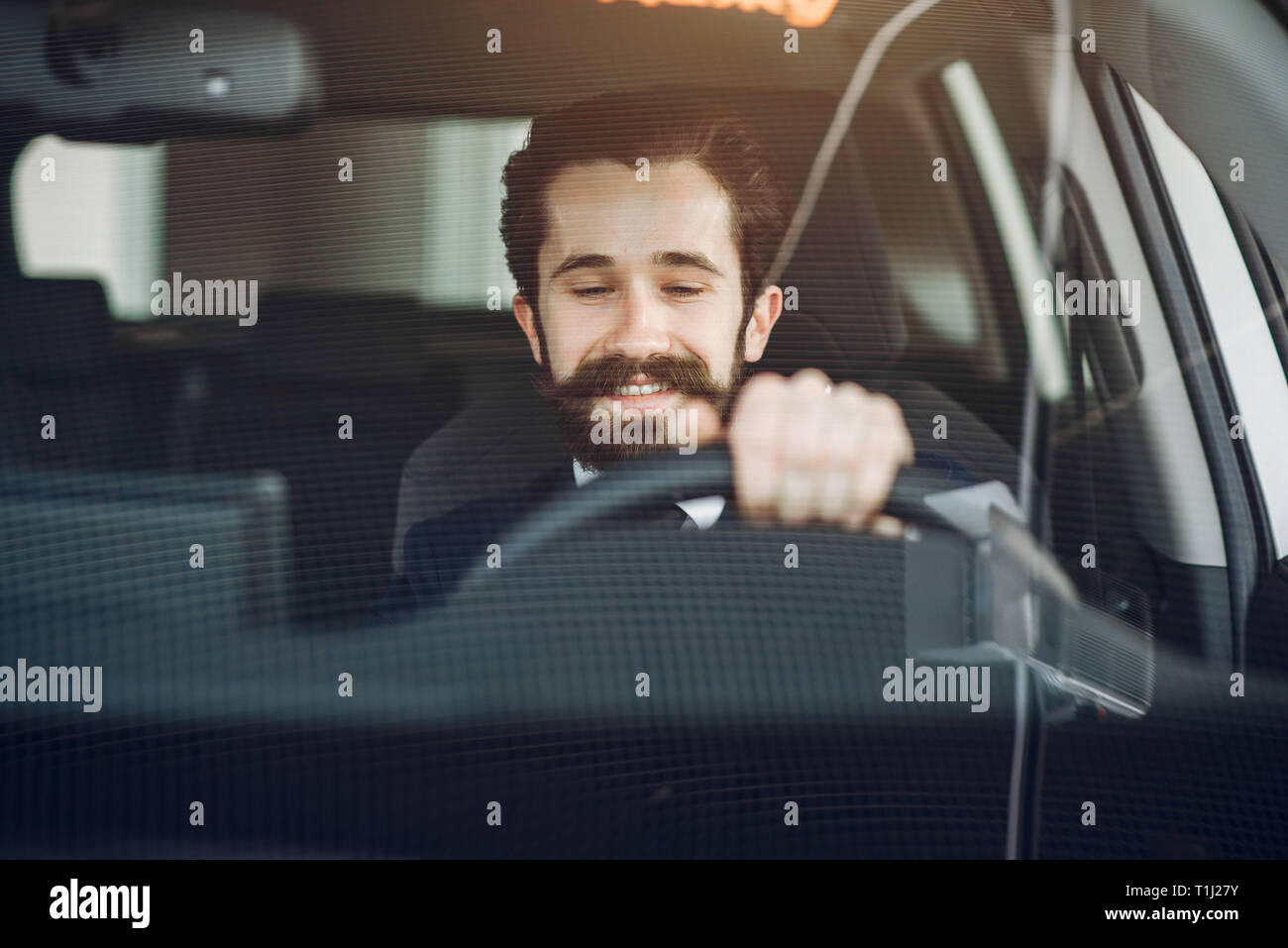Handsome and elegant man in a car salon Stock Photo - Alamy