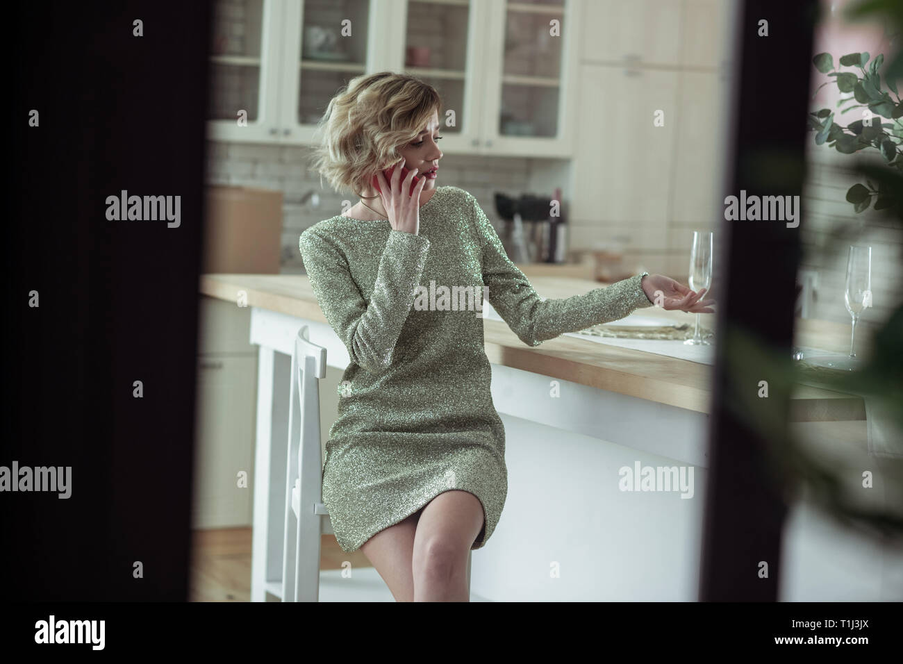 Elegant girlfriend calling her man while staying alone at apartment ...