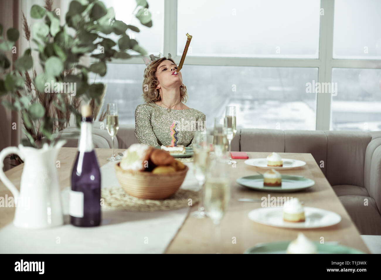 Birthday woman sitting at the empty table with food and alcohol Stock ...
