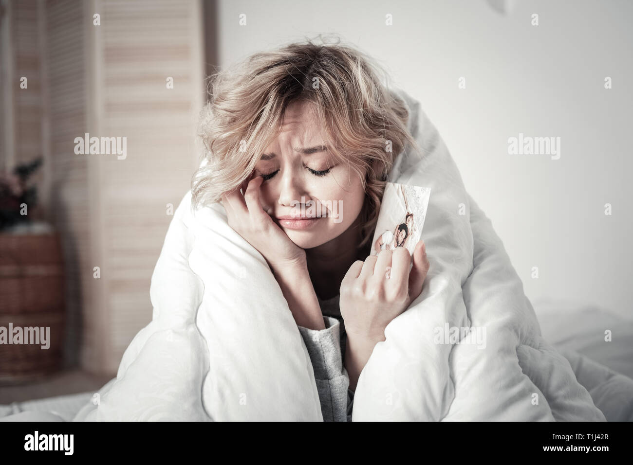 Sentimental woman crying while remembering her relationship Stock Photo ...