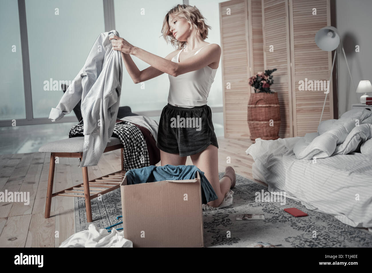 Sad woman packing boxes hi-res stock photography and images - Alamy