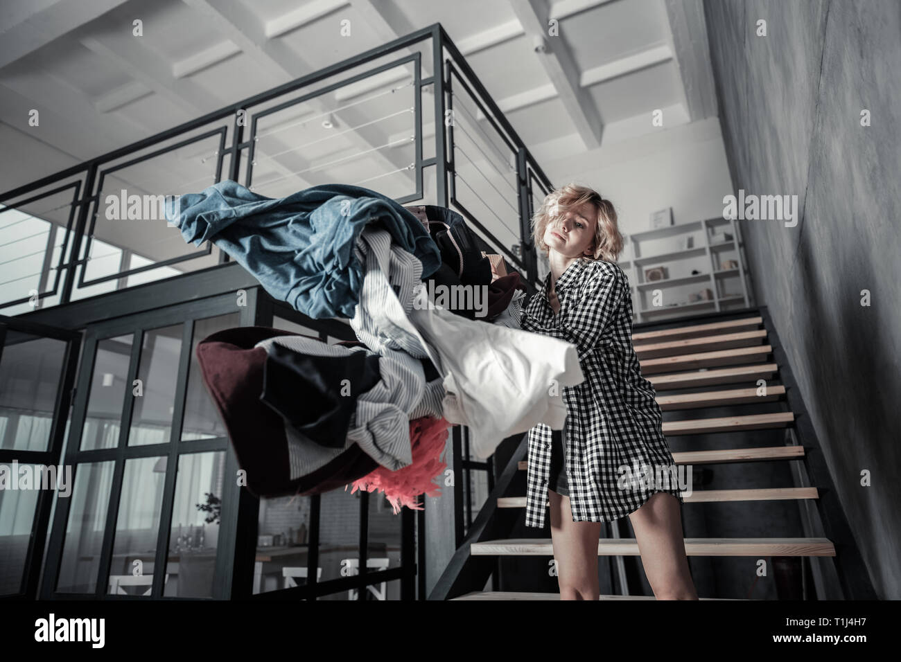 Wife throwing clothes of husband away from her apartment Stock Photo ...