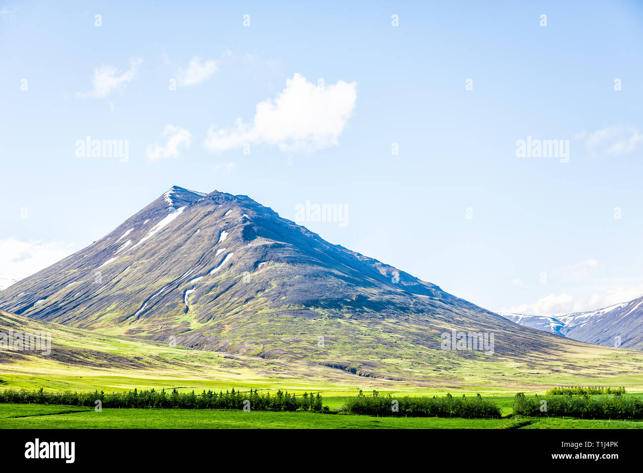 View on Sulur mountain near Akureyri with blue sky and field meadow ...